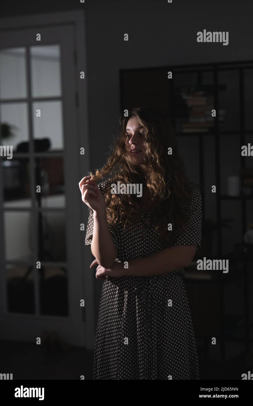 Serious beautiful young woman in dress posing for the camera Stock ...