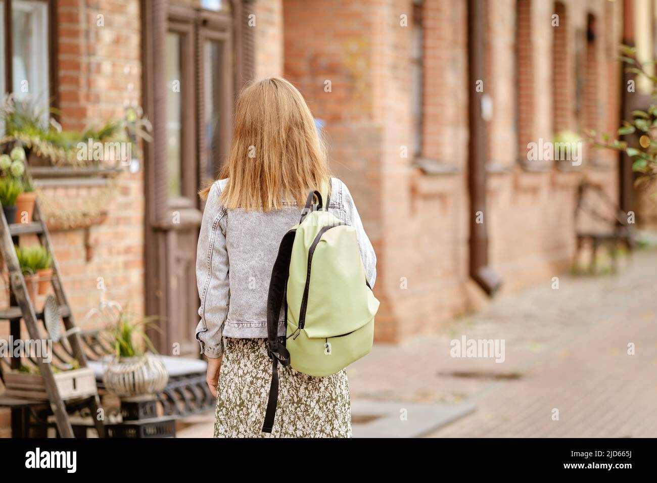 Cute tourist woman in old town, back view Stock Photo - Alamy