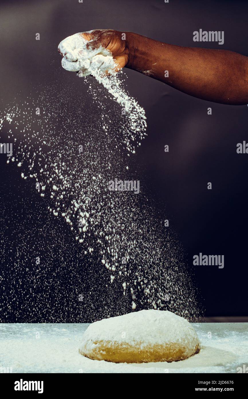 Hands splashing wheat flour kneaded Stock Photo - Alamy