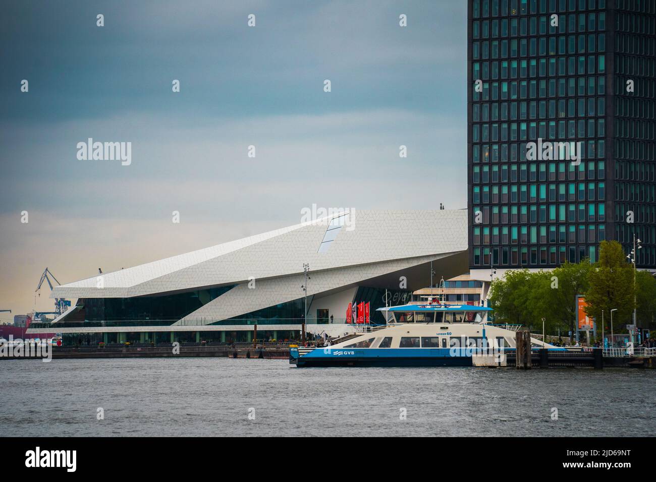 Modern building next to water Stock Photo - Alamy