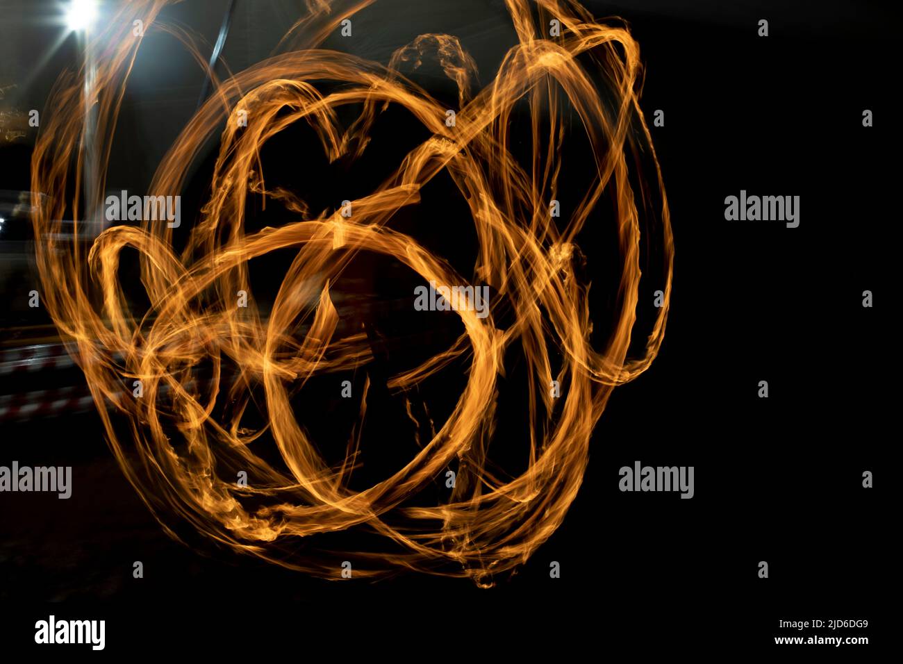 Circles of fire. Lines of flame. Shooting fire show on long shutter ...