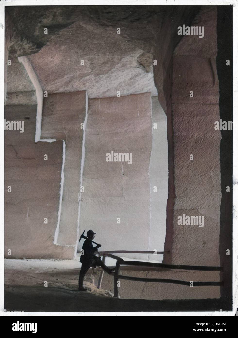 Hungarian salt mines. A miner rests his pickaxe over his shoulder as he ...