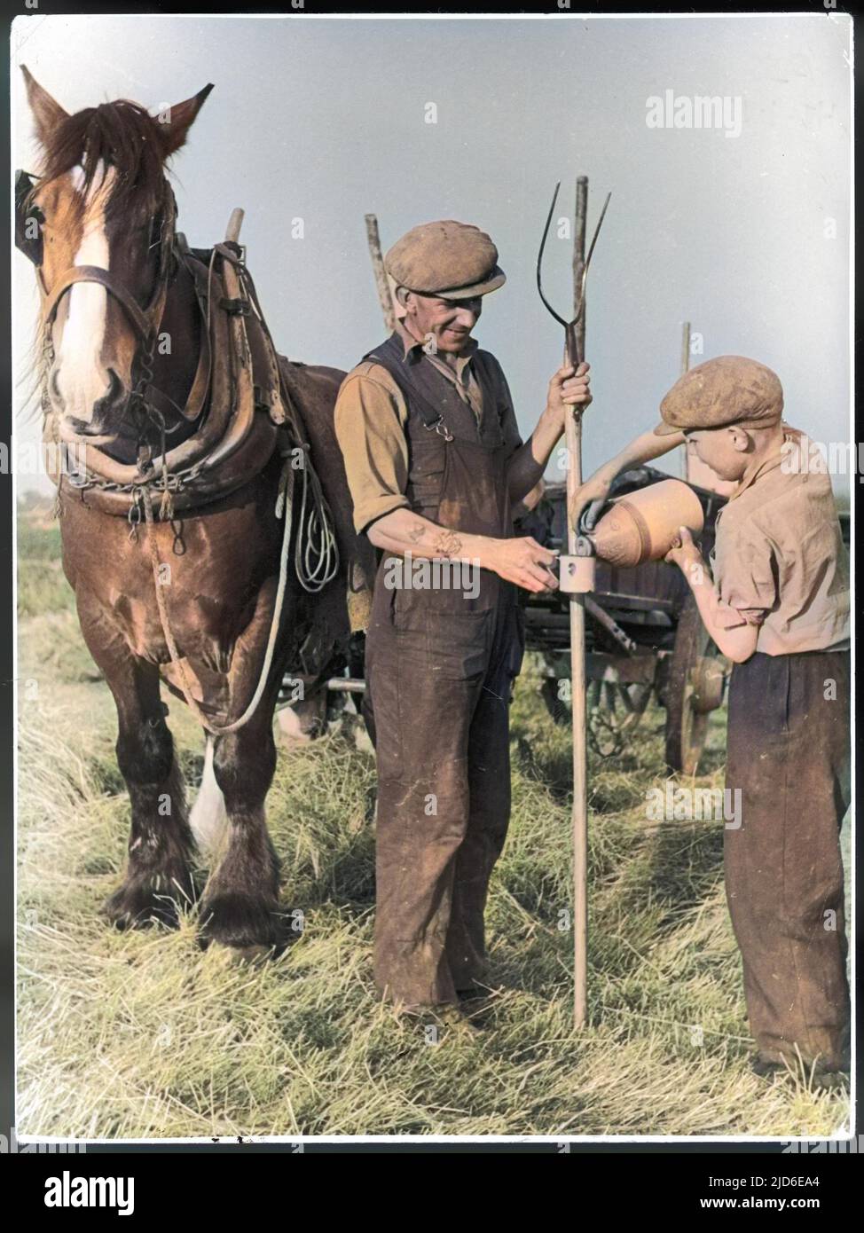 After a hard morning ploughing, two Kentish farm workers take a well ...