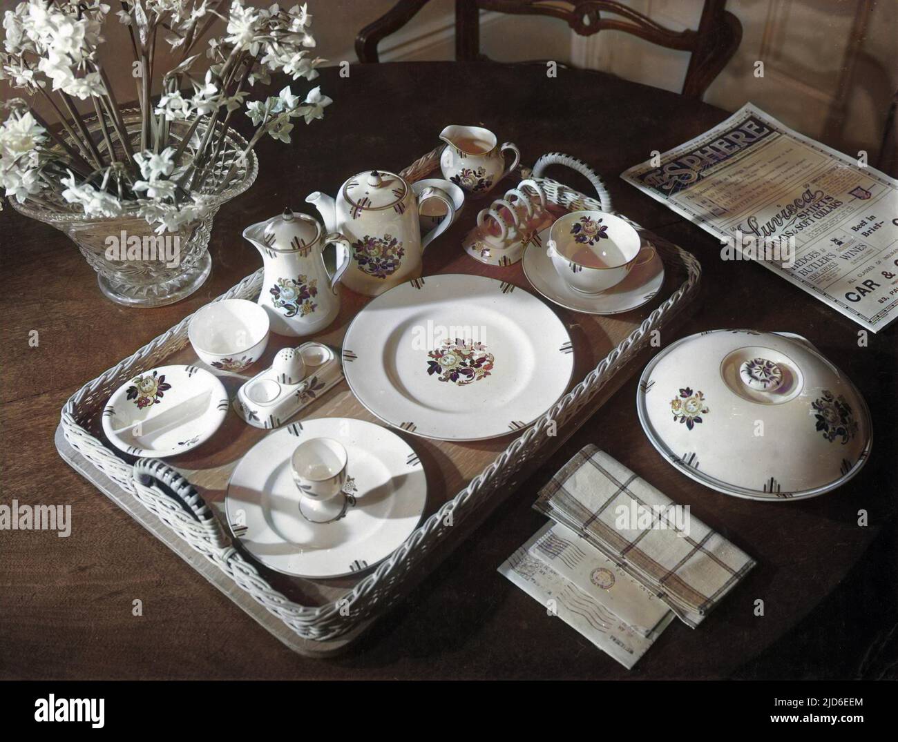 A wonderful breakfast set in dainty china, served on a wicker tray. A ...