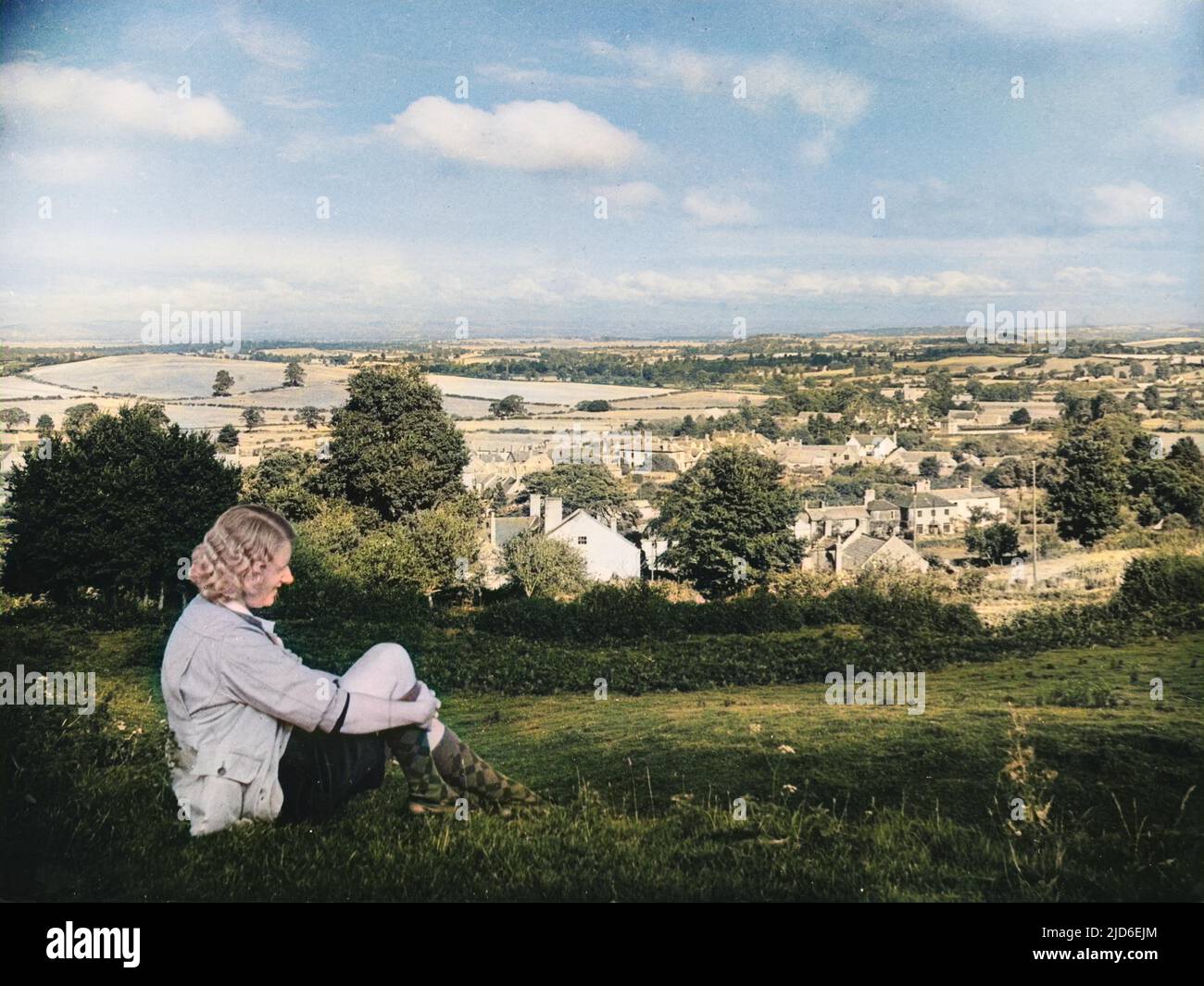 A young female rambler takes time out to sit and rest and admire the ...