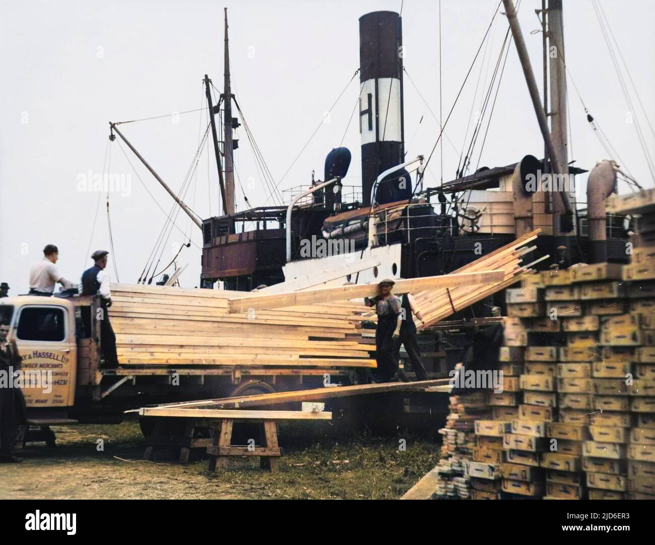 Workmen unloading a timber boat at Bristol docks, Gloucestershire ...