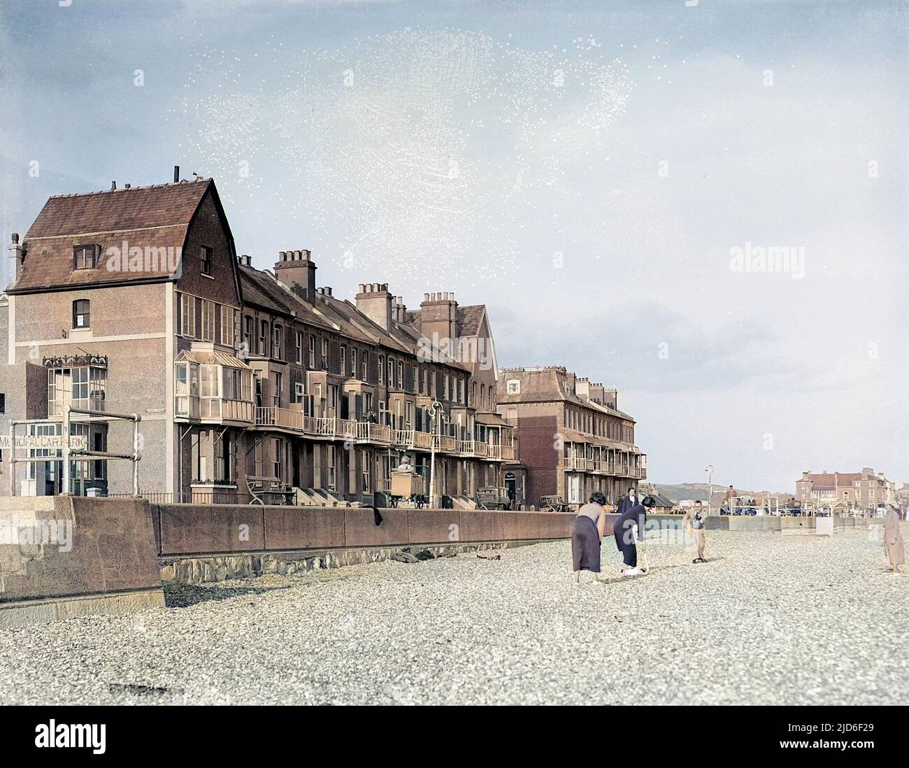 A group of young people playing a game of cricket on the pebble beach at Hythe, near Folkestone ...