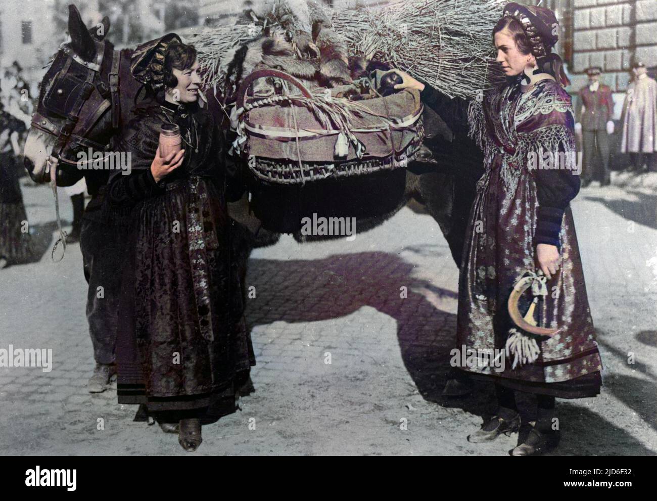 Two Italian peasant girls in traditional dress, selling goods from ...