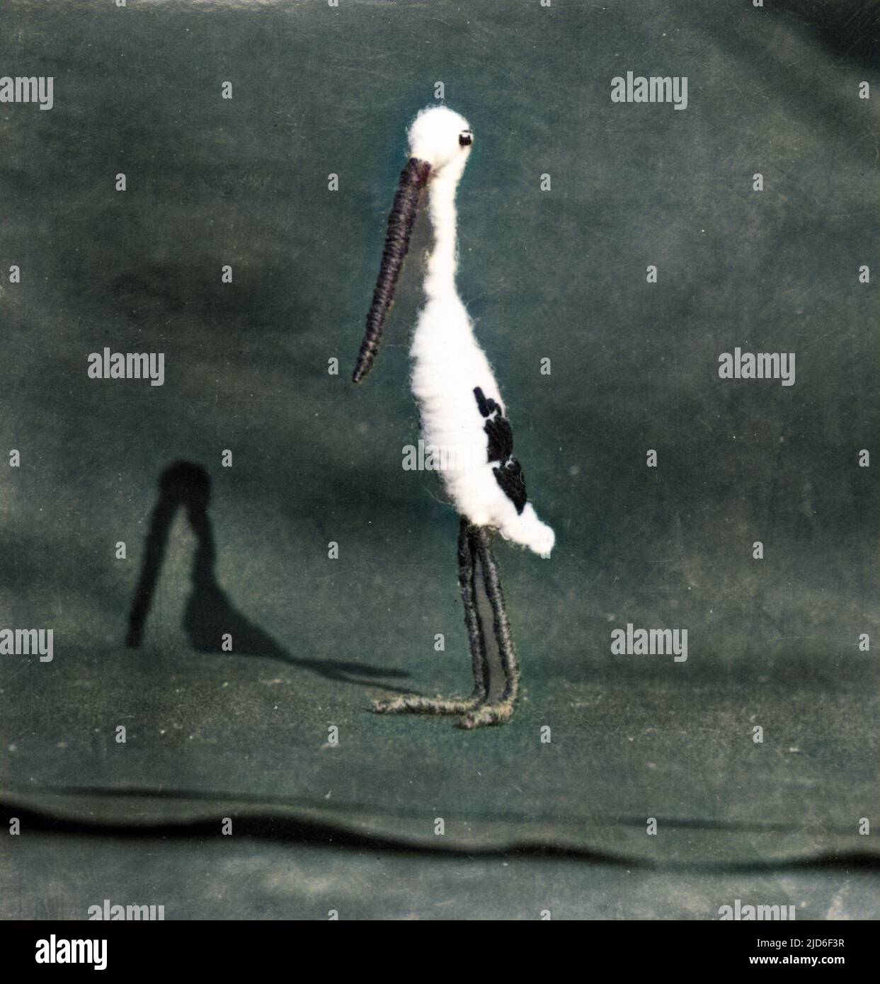 A toy stork, a mascot made of wire and wool. Colourised version of ...