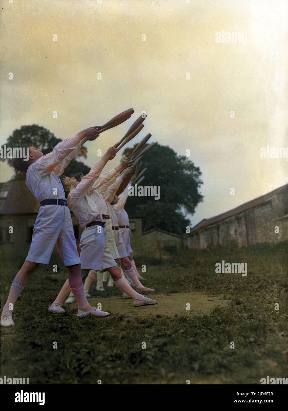 Boys marching and swinging clubs together. Colourised version of ...