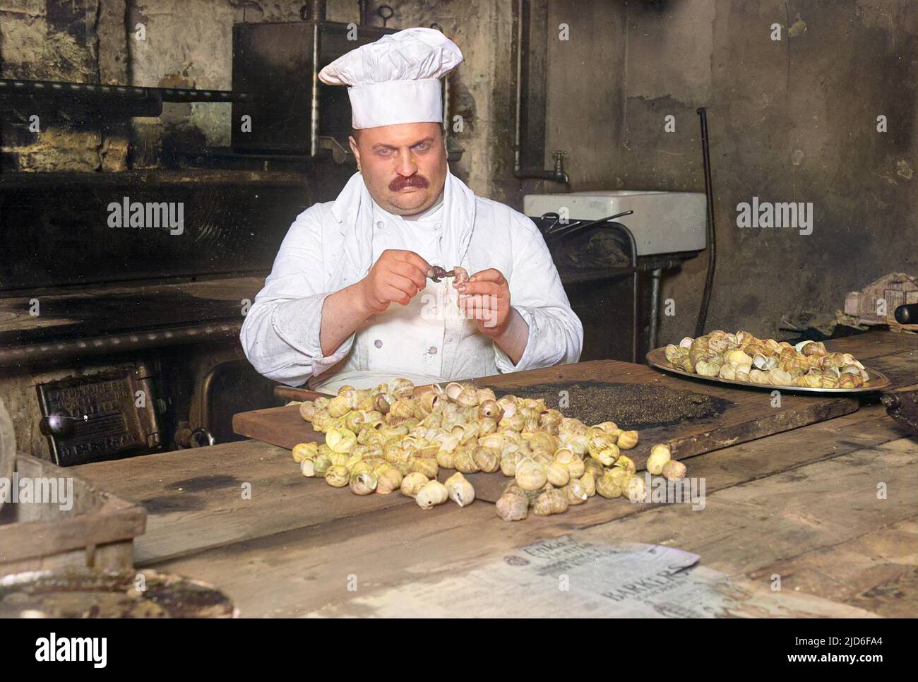 A French chef preparing snails for eating. Colourised version of ...