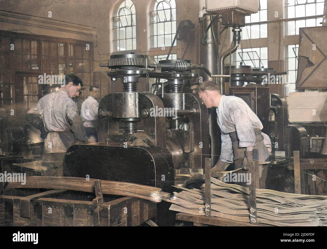 Bars of gold being fed into the stamping machines at the Royal Mint ...