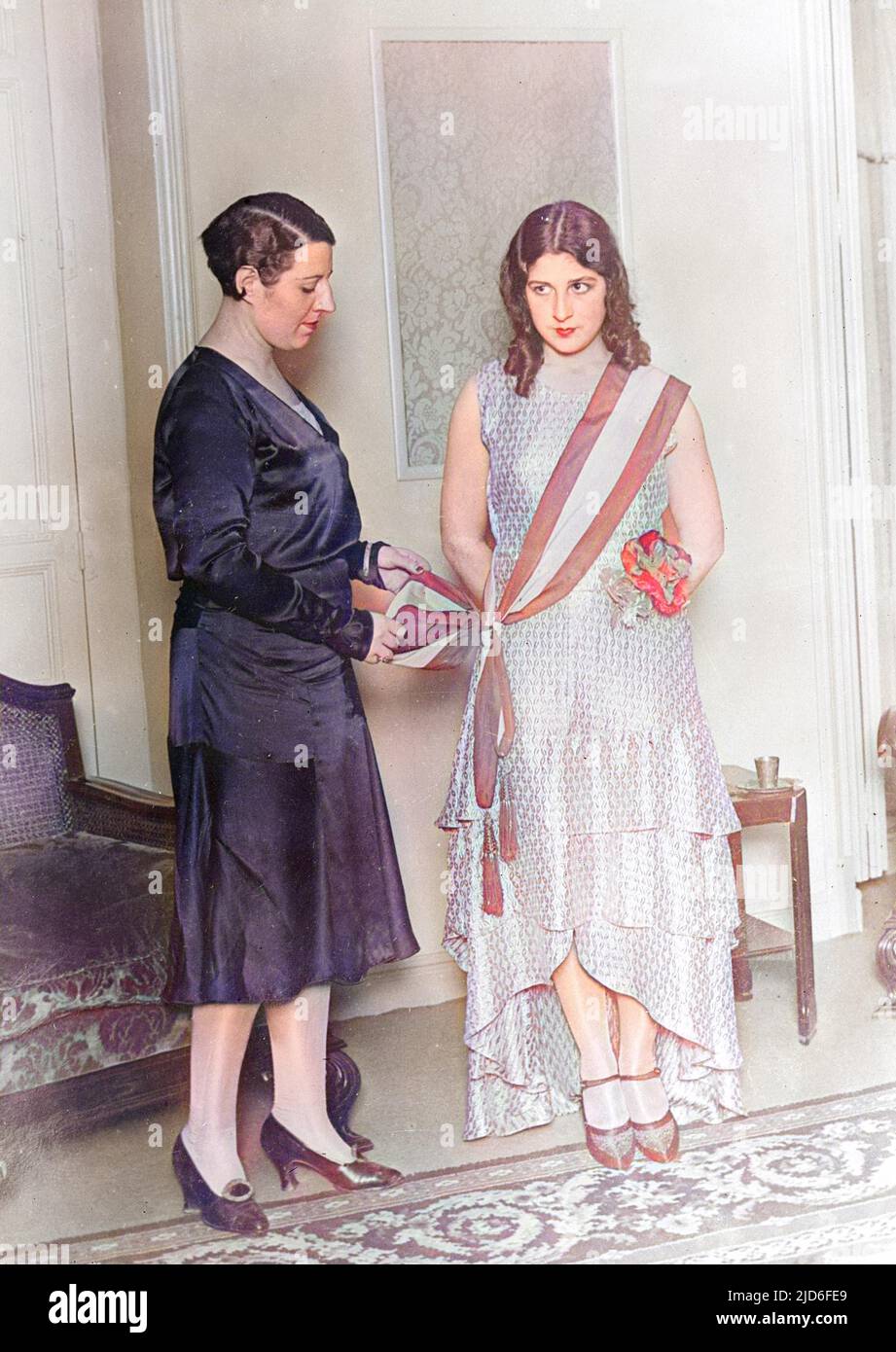 Clara Ola, beauty queen and 'Miss Spain', having her sash adjusted by ...