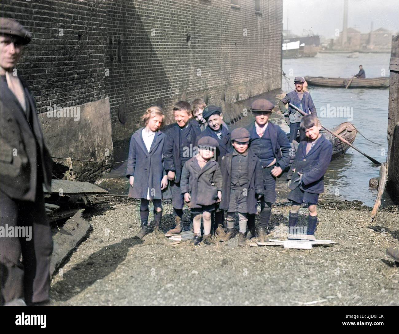 A group of working class kids on a small 'beach' beside the River ...