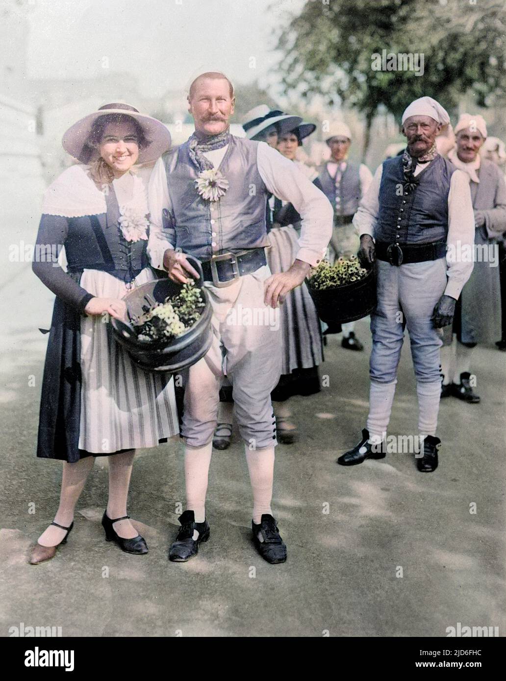 Happy men and women in traditional peasant costumes during the annual ...