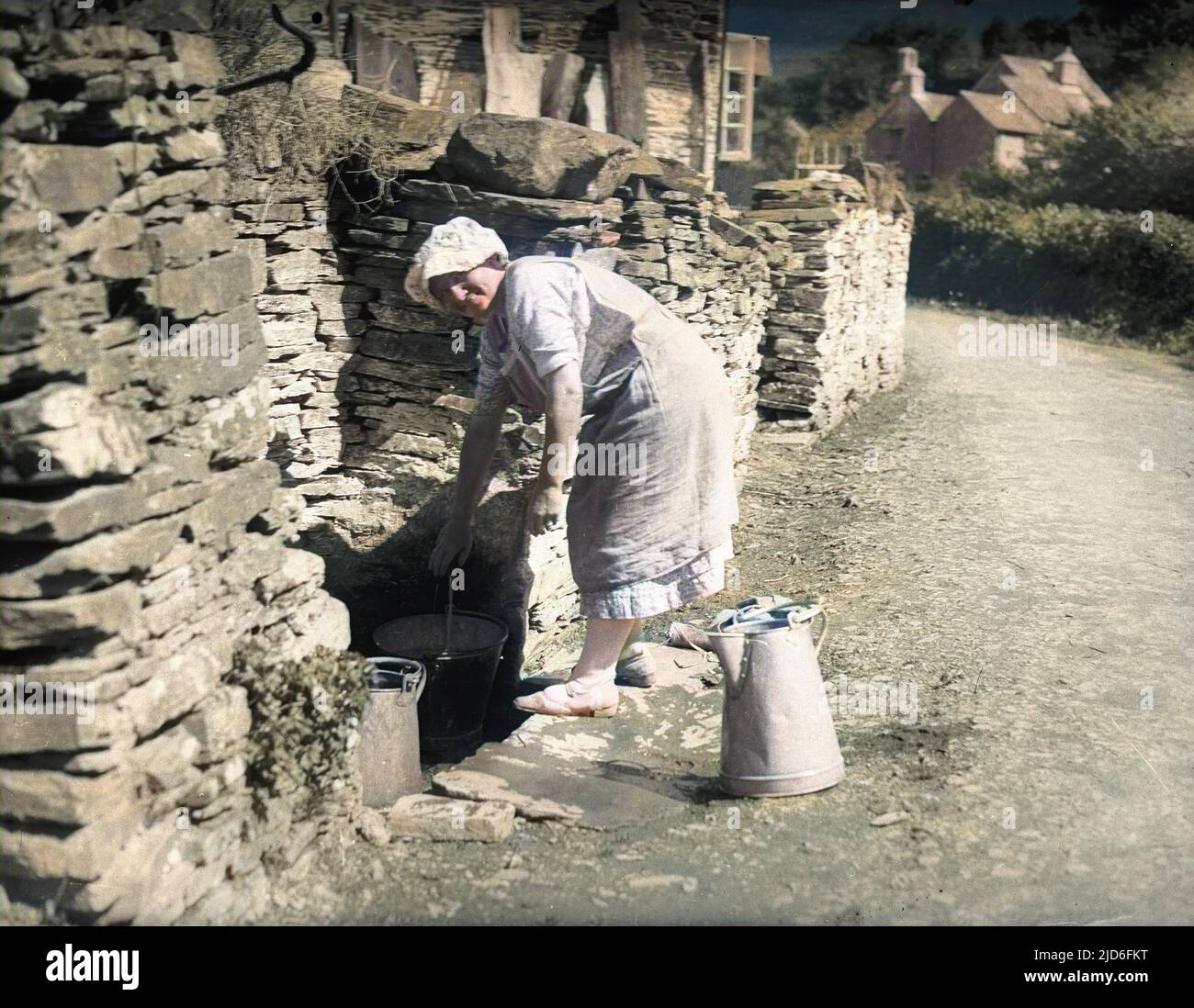 A country lass fetches water from the well in Milton Coombe, South ...