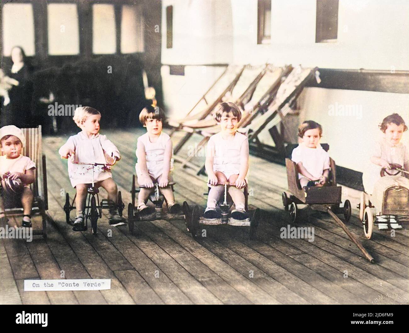 Toddlers take part in a tricycle race on the deck of the Italian ship ...