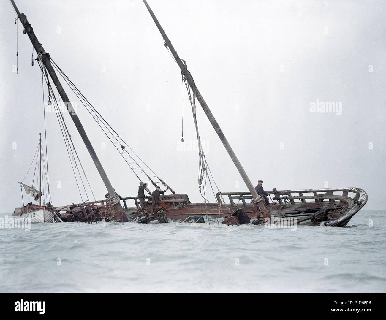 Men salvaging a Ramsgate fishing smack which has run aground at Herne ...