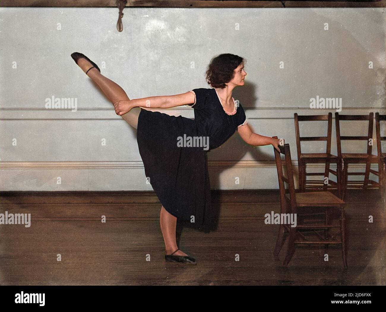 A young woman demonstrates how to perform 'physical jerks' (bending and ...