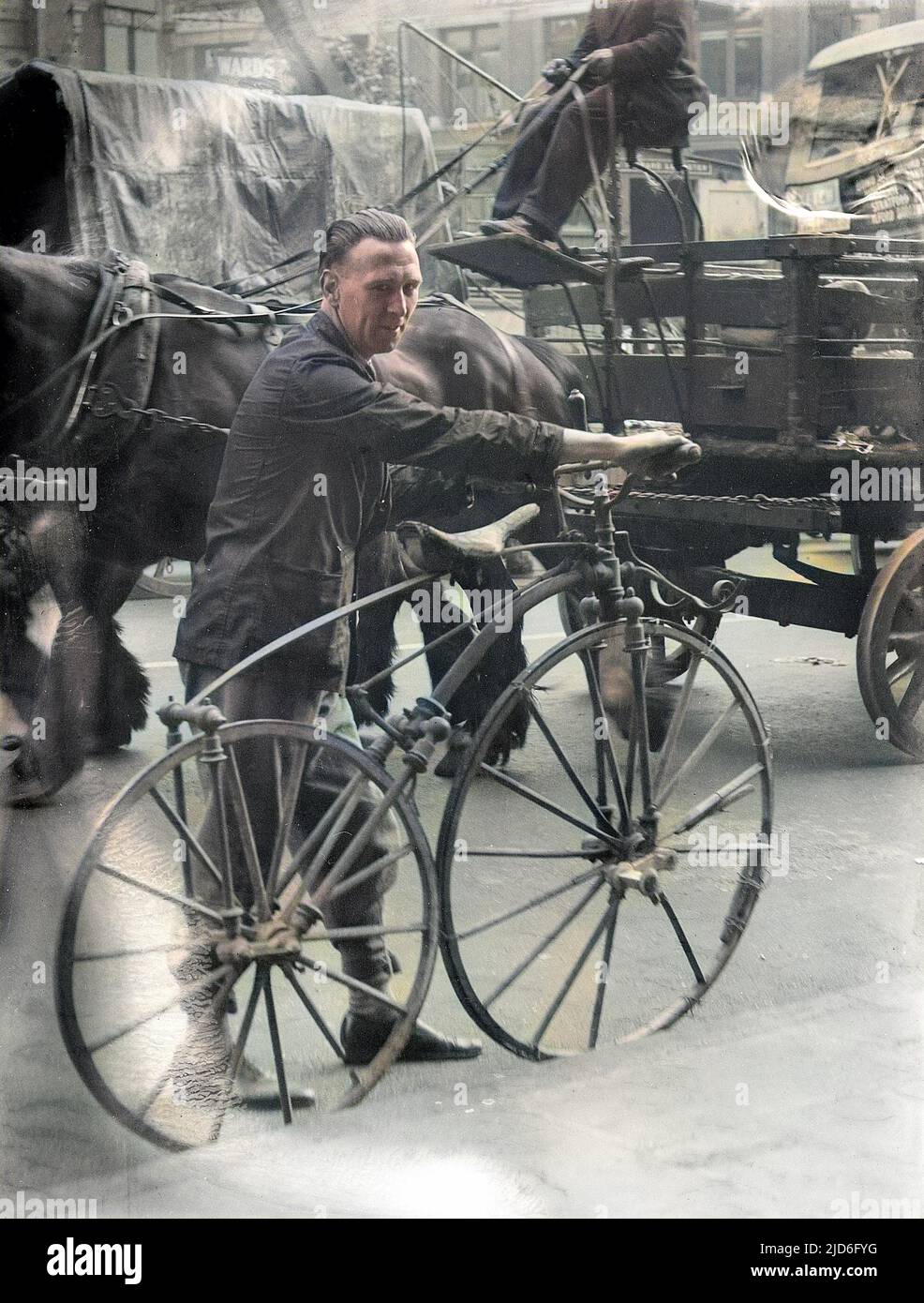 A man pushing his 'boneshaker' velocipede bicycle in Holborn, central ...