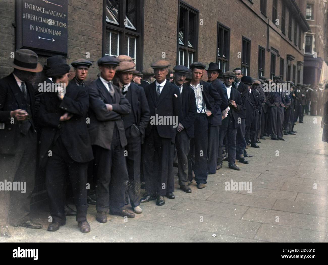 Unemployed working class men queueing for the Dole during the ...