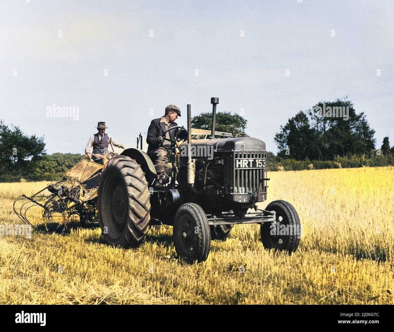Havesting barley on a farm in Suffolk, England, using a Fordson tractor ...