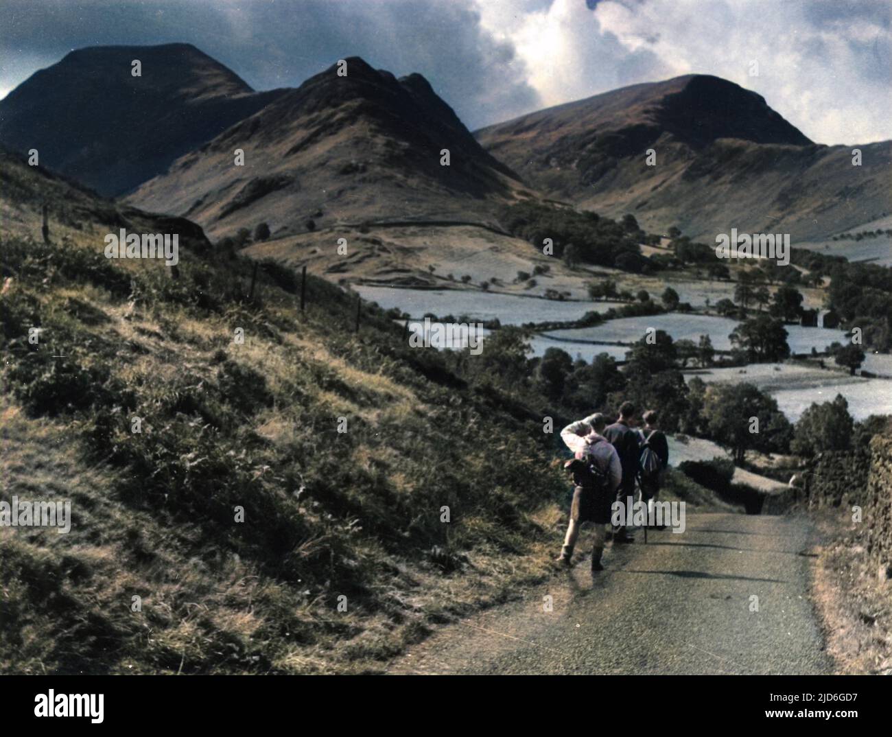 Three ramblers stop to admire the view of the Newlands Valley, Cumbria ...