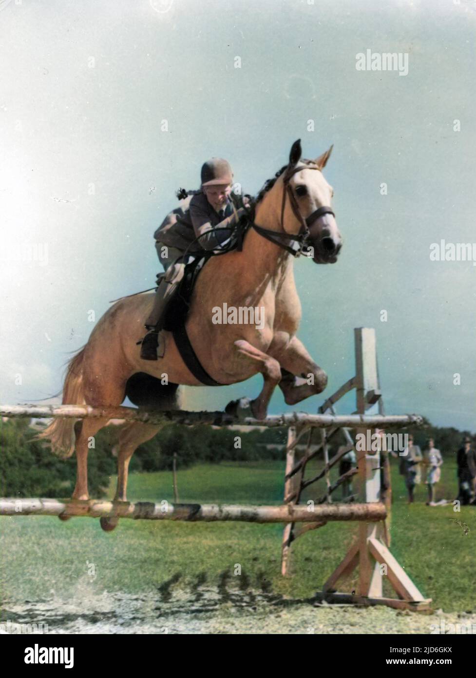 A happy girl Show Jumping with her horse over a hurdle. Colourised ...