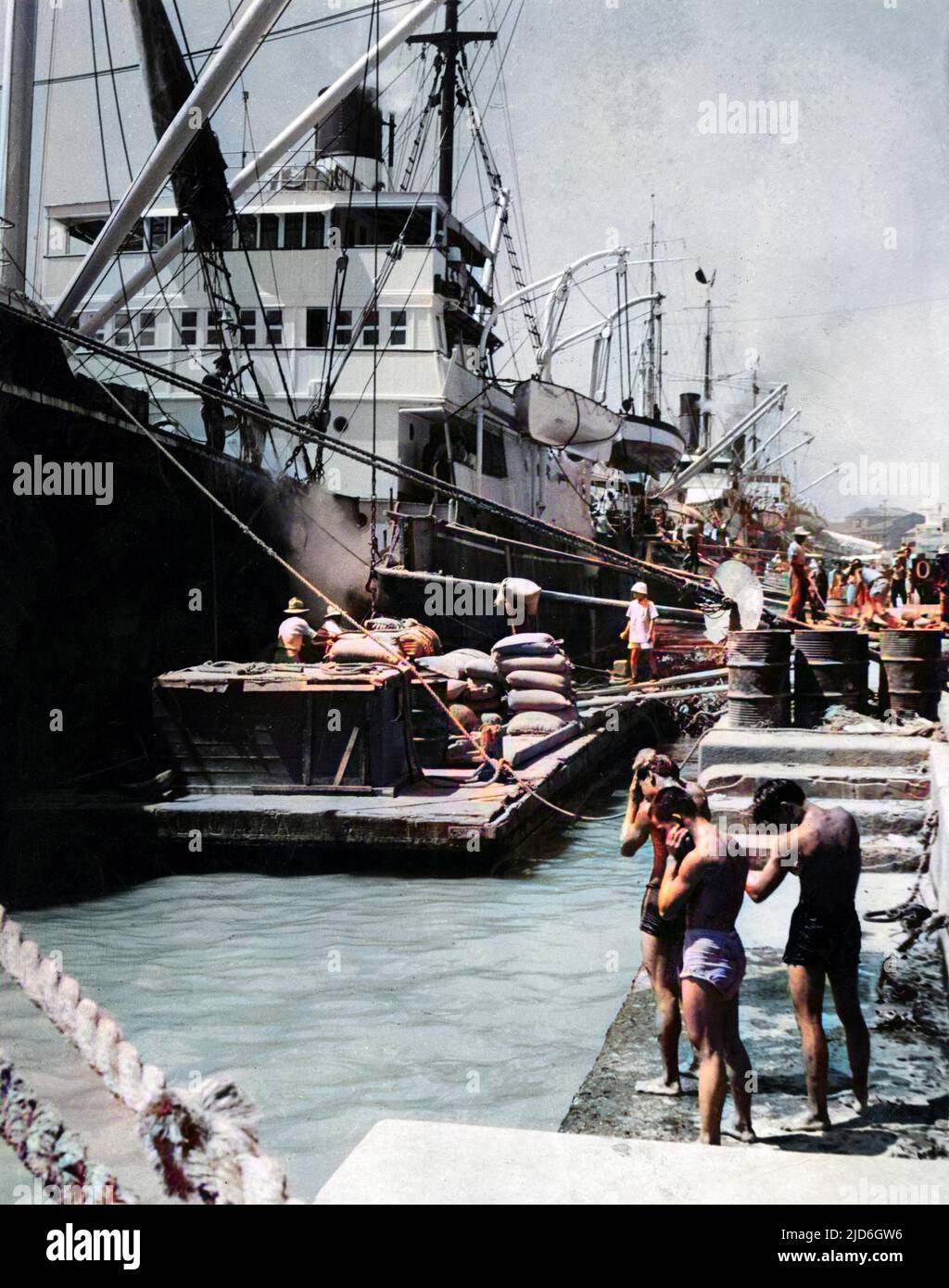 Unloading a shipment of cargo from ships in Manila docks, Philippines ...
