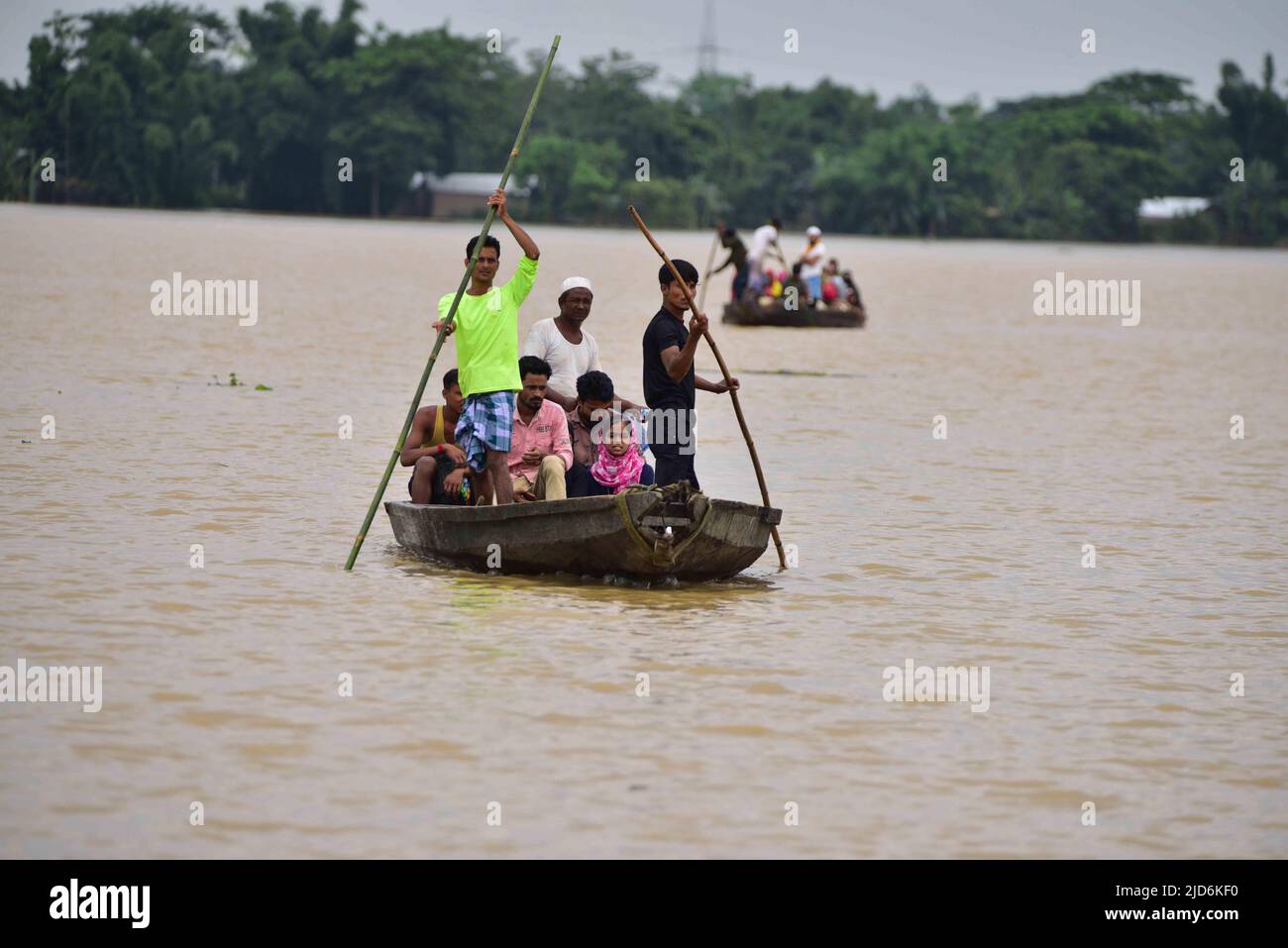 Hojai. 18th June, 2022. Villagers row boats to a safer place in Hojai ...