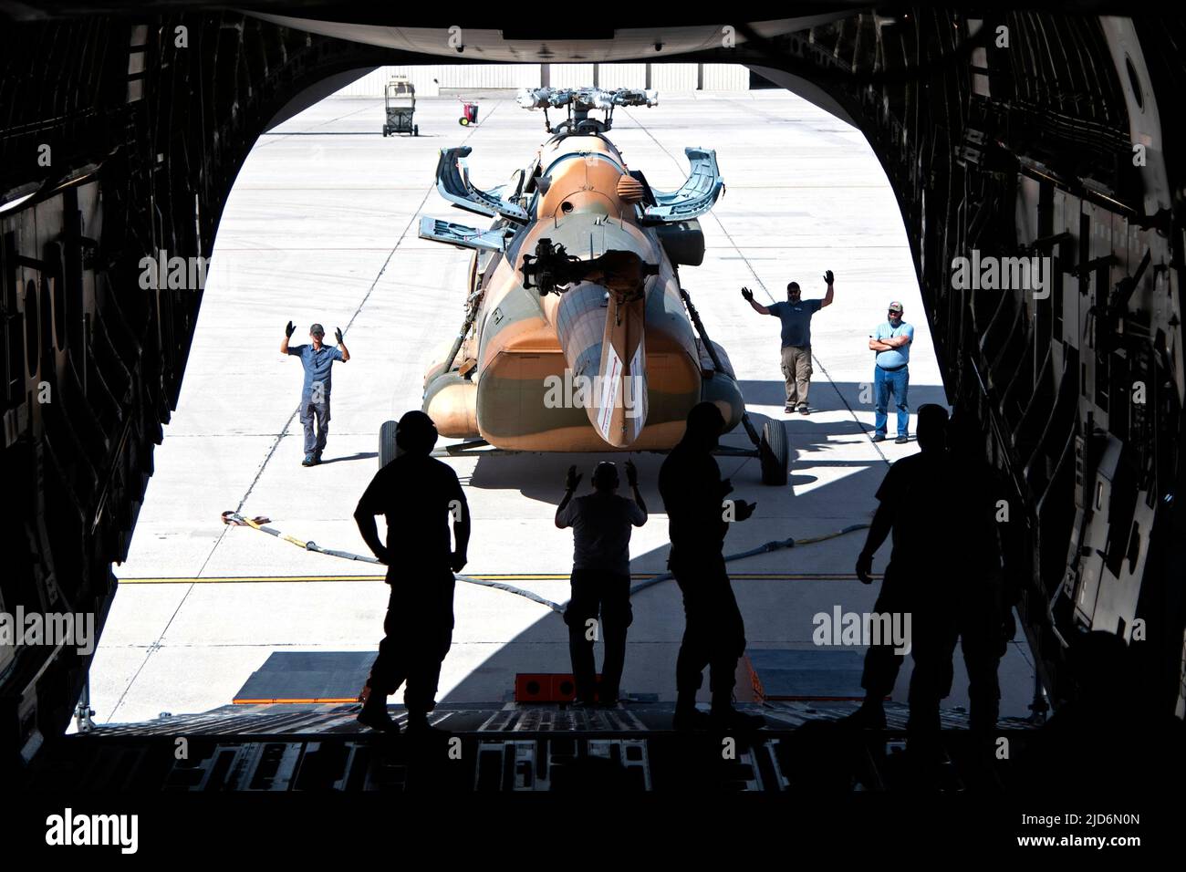 An Mi-17 helicopter is loaded on to a C-17 Globemaster III aircraft at ...