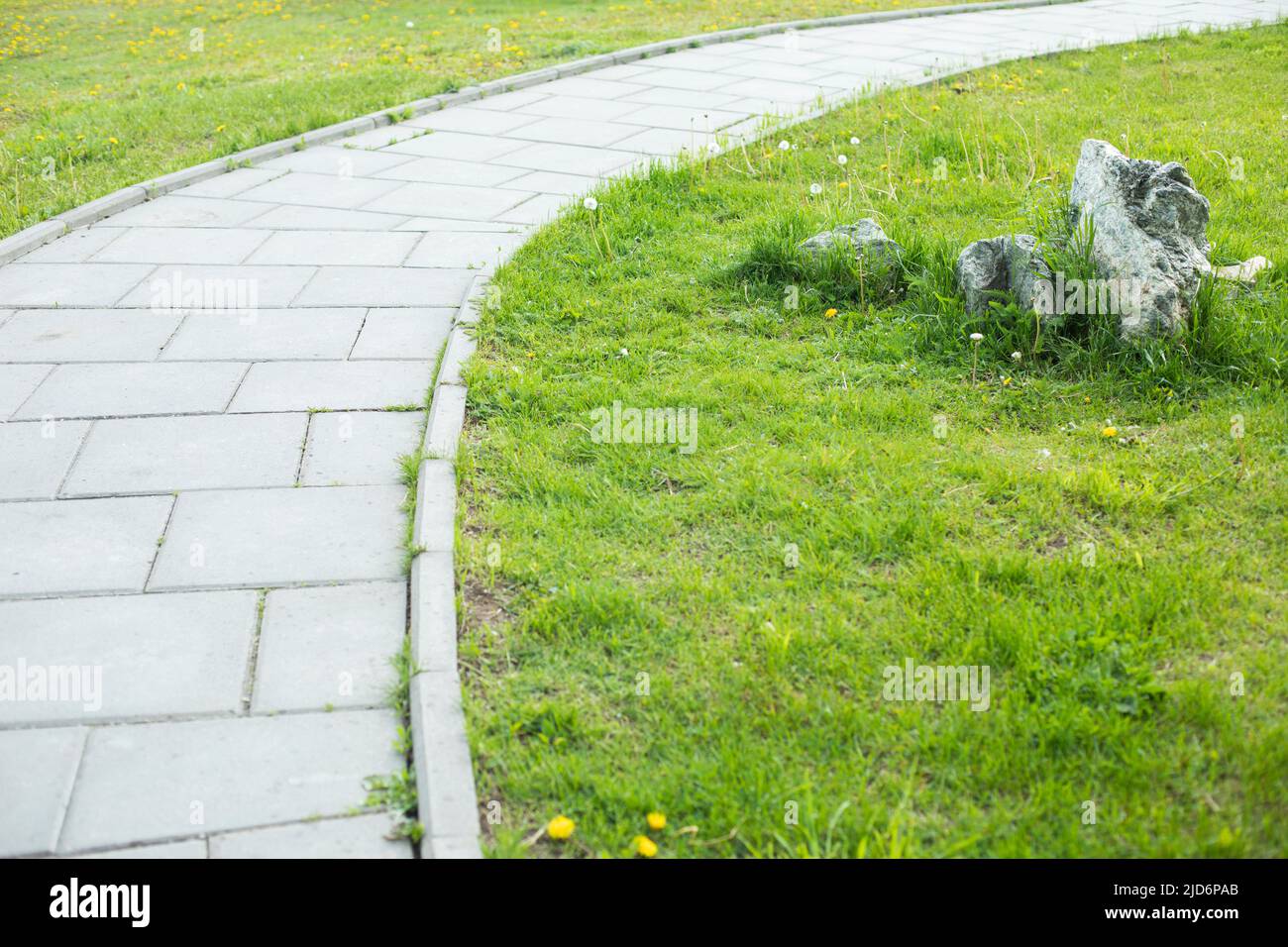 Park path and green grass. Details of city park. Tiles on road Stock ...