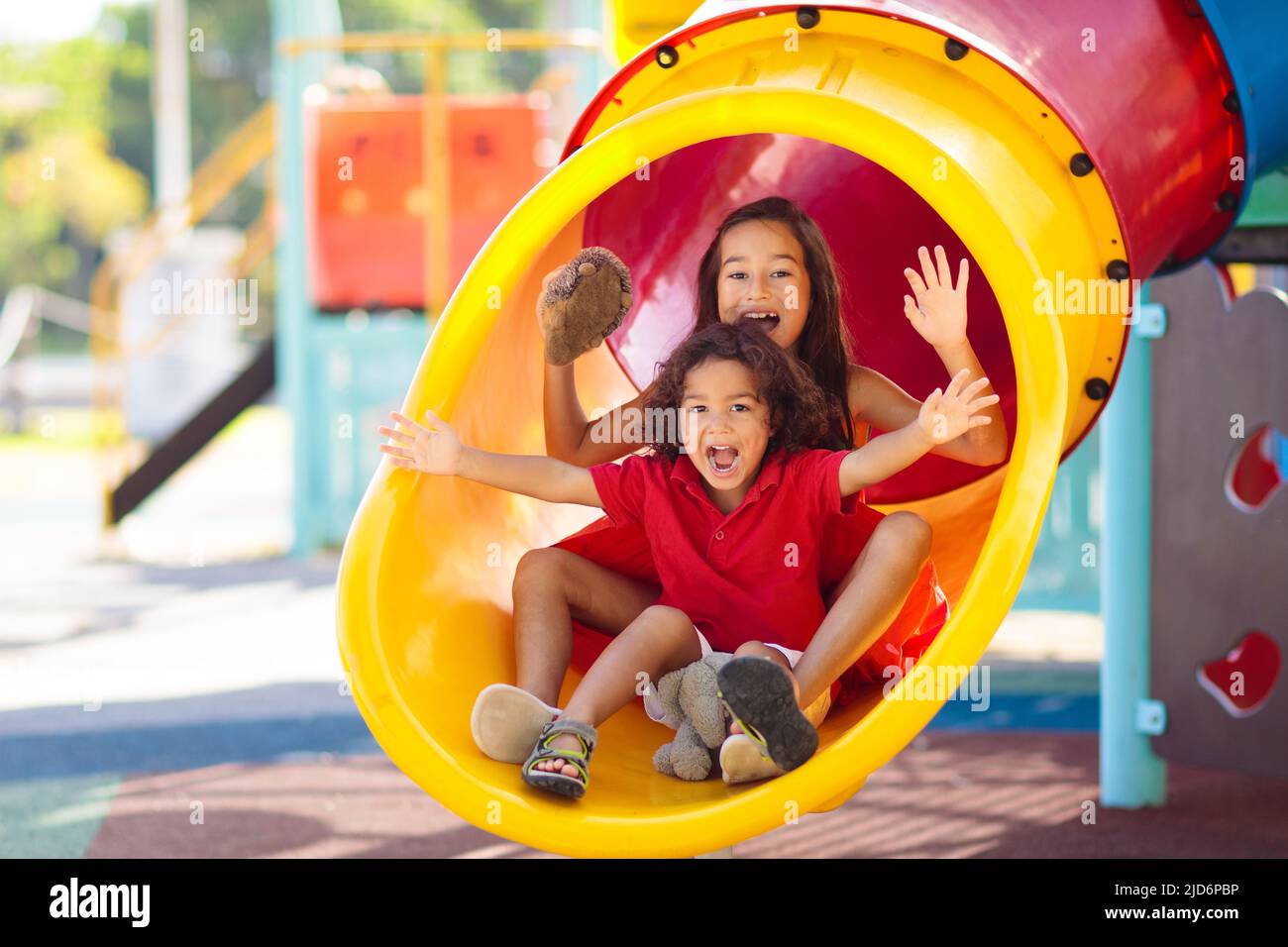 Kids on playground. Children play outdoor on school yard slide. Healthy ...