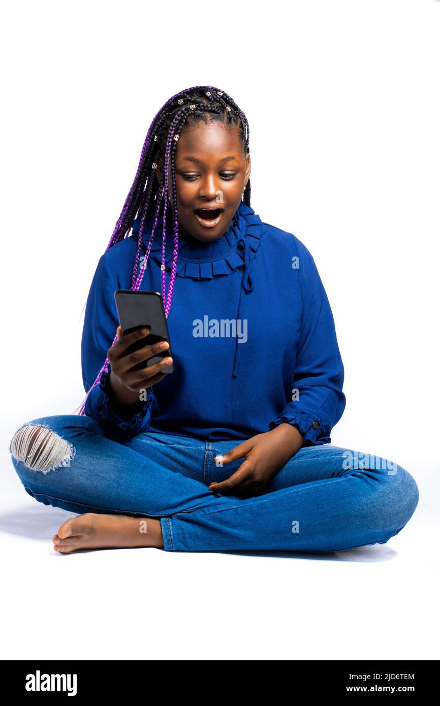 Girl surprised looking into her phone Stock Photo - Alamy