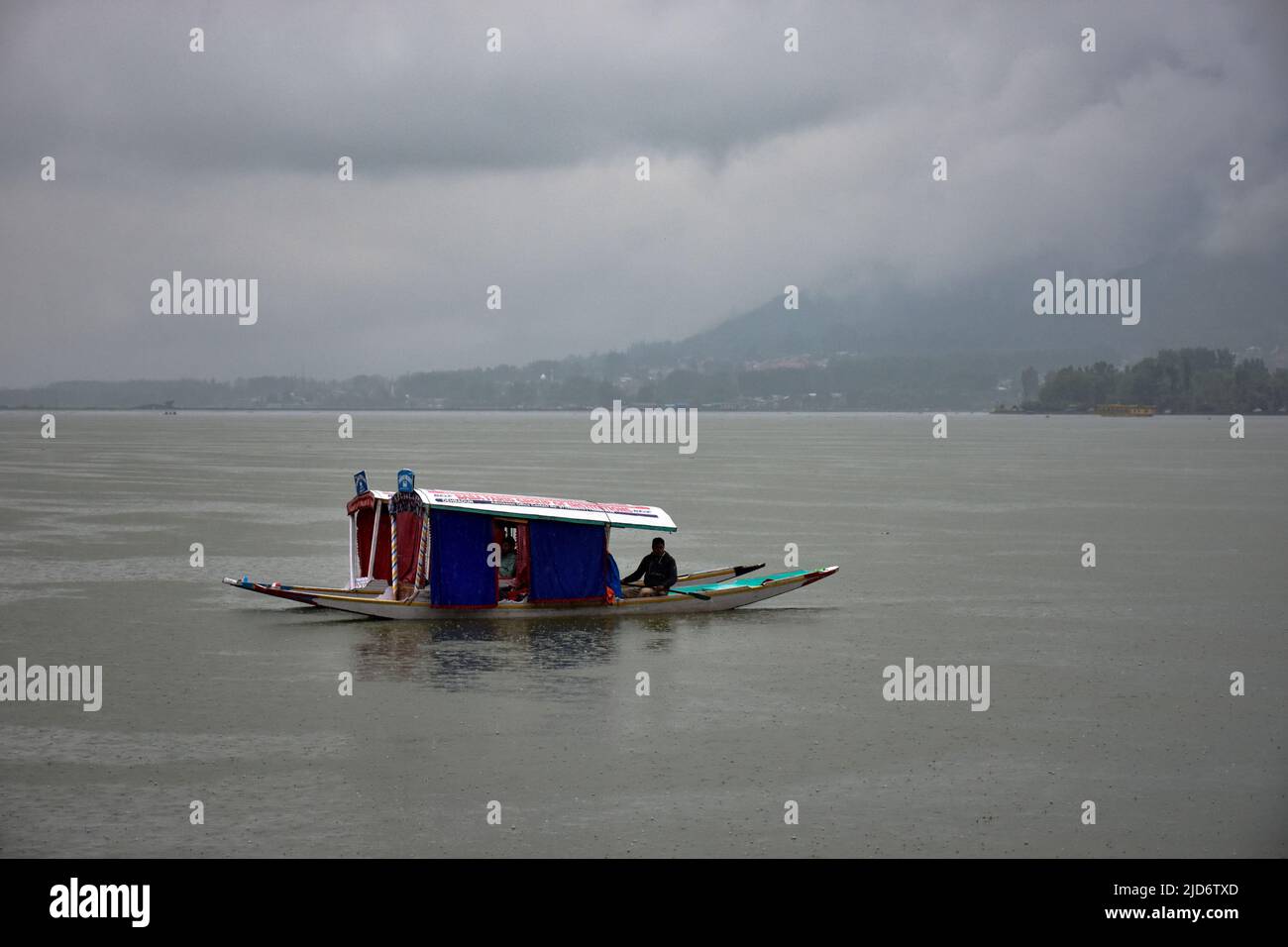 Srinagar, India. 18th June, 2022. A boatman rows his boat across the ...