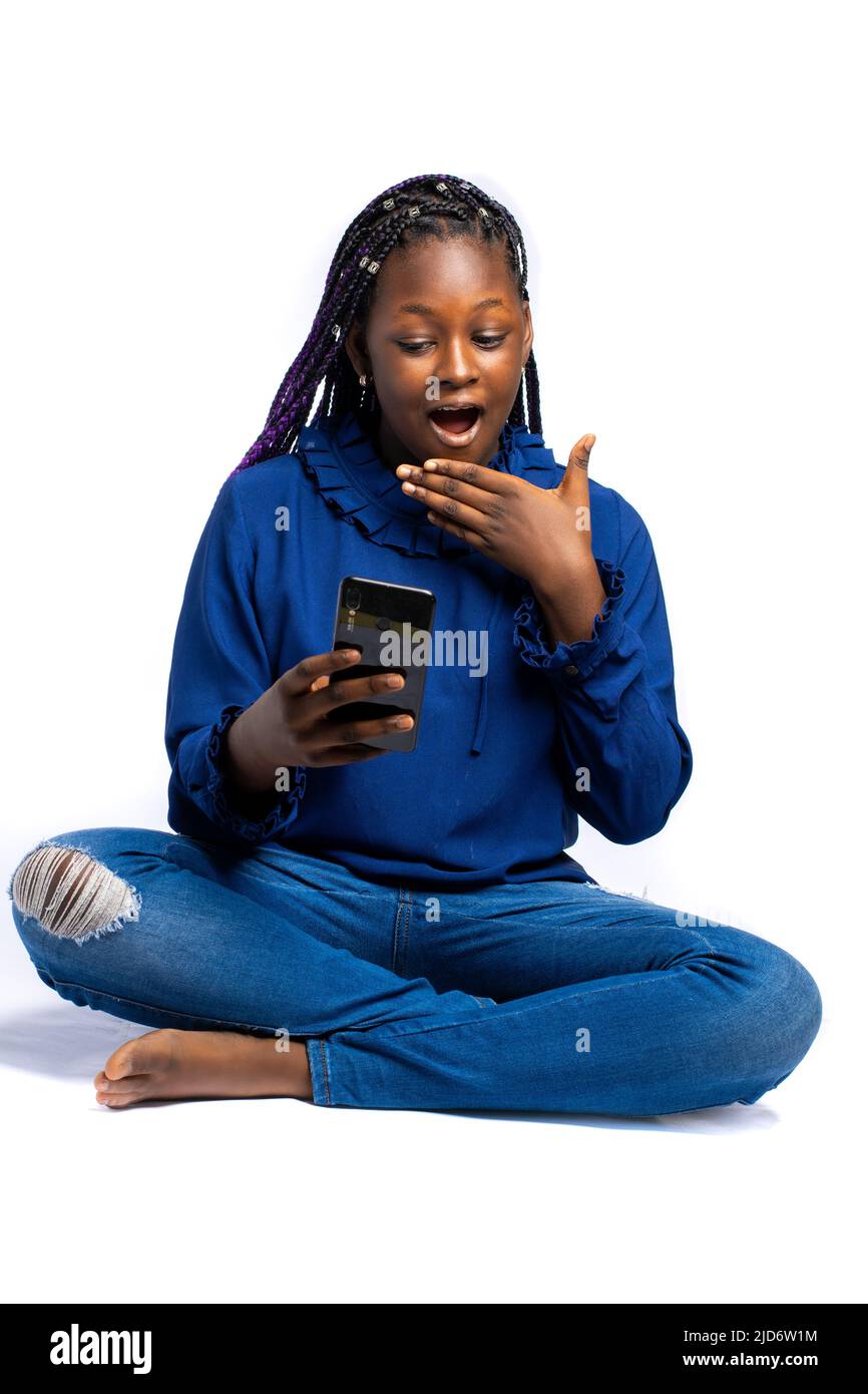 Girl surprised looking into her phone Stock Photo - Alamy