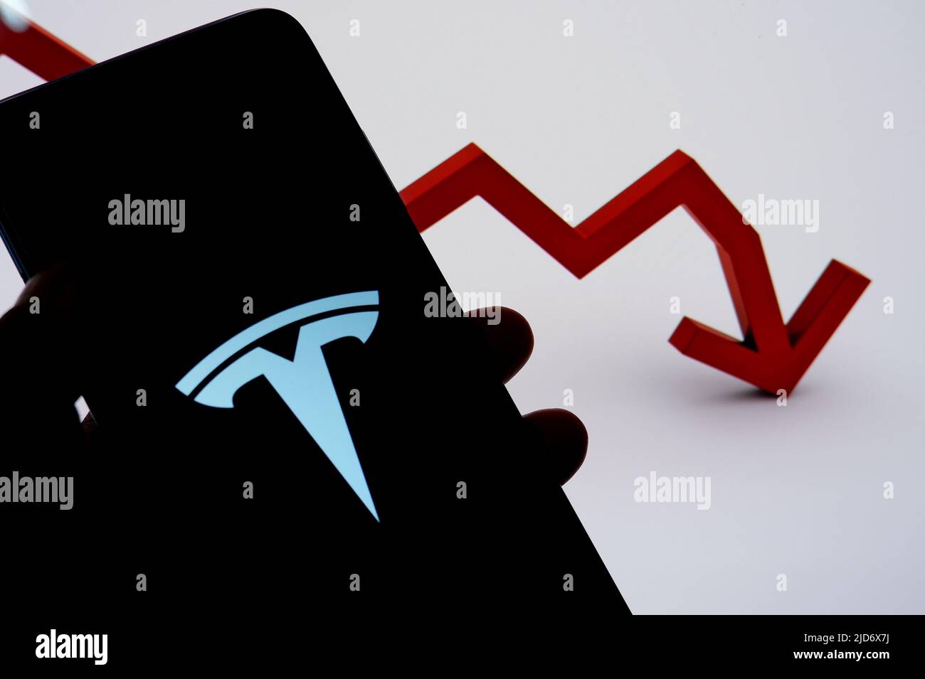 In this Photo illustration a Tesla brand logo seen displayed on an ...