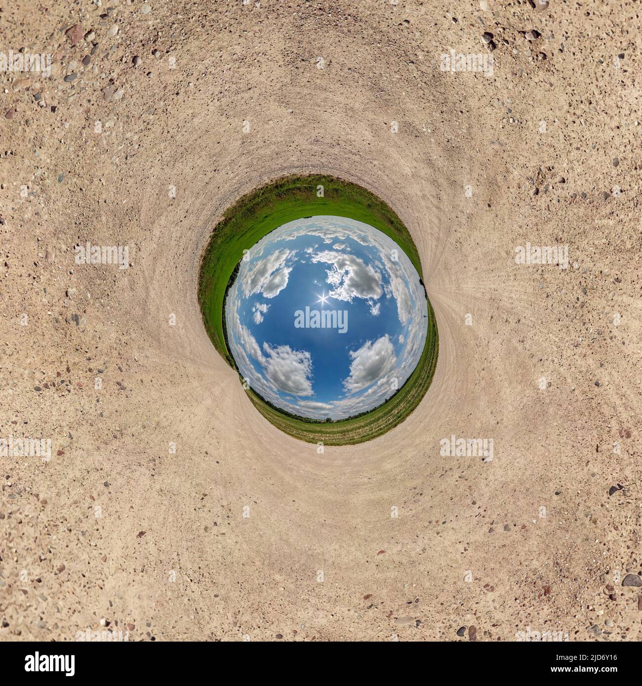 blue sphere little planet inside gravel road or field background ...