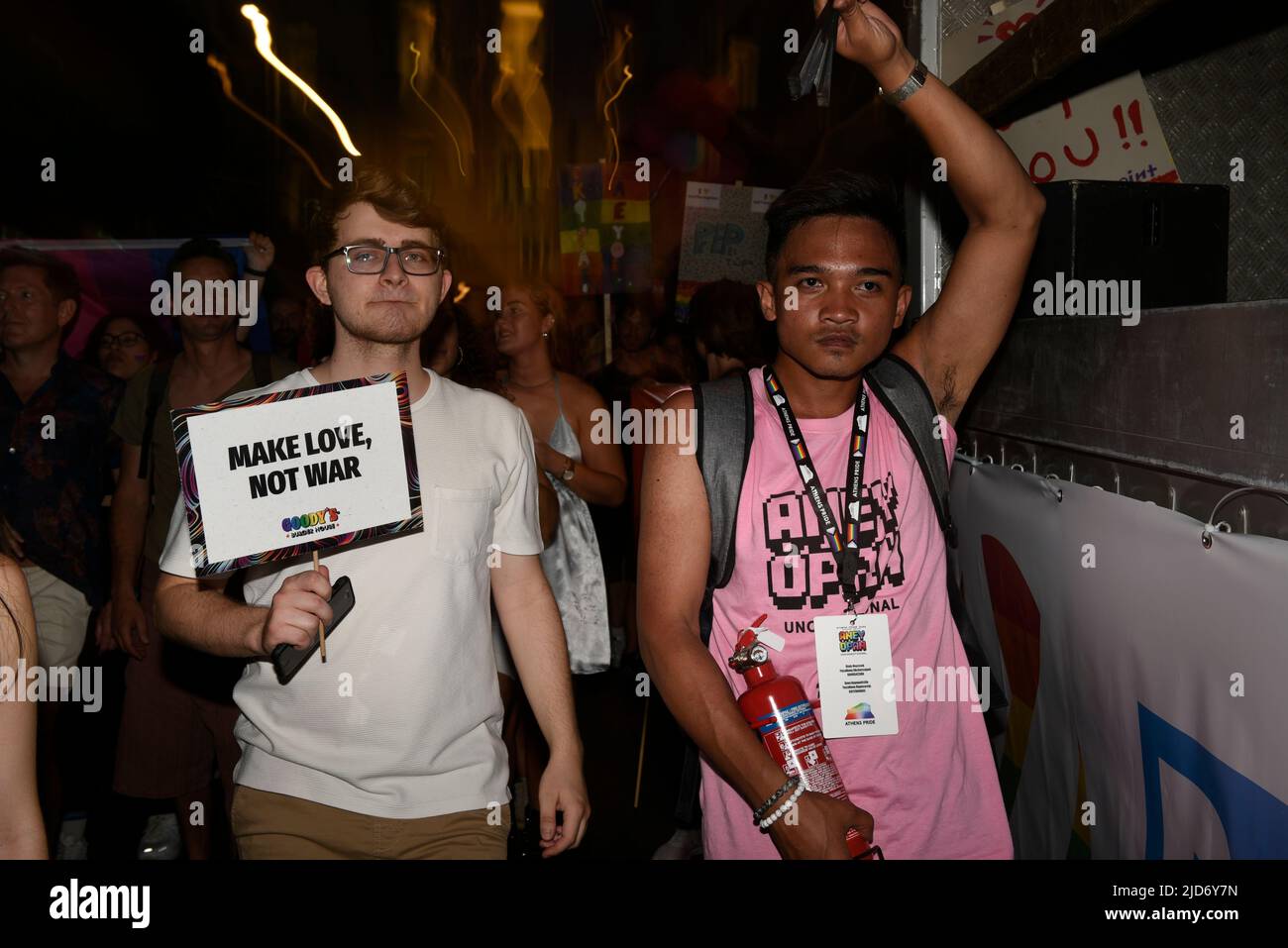 Athens, Greece. 18th June, 2022. People march waving rainbow flags and holding placards, during ...