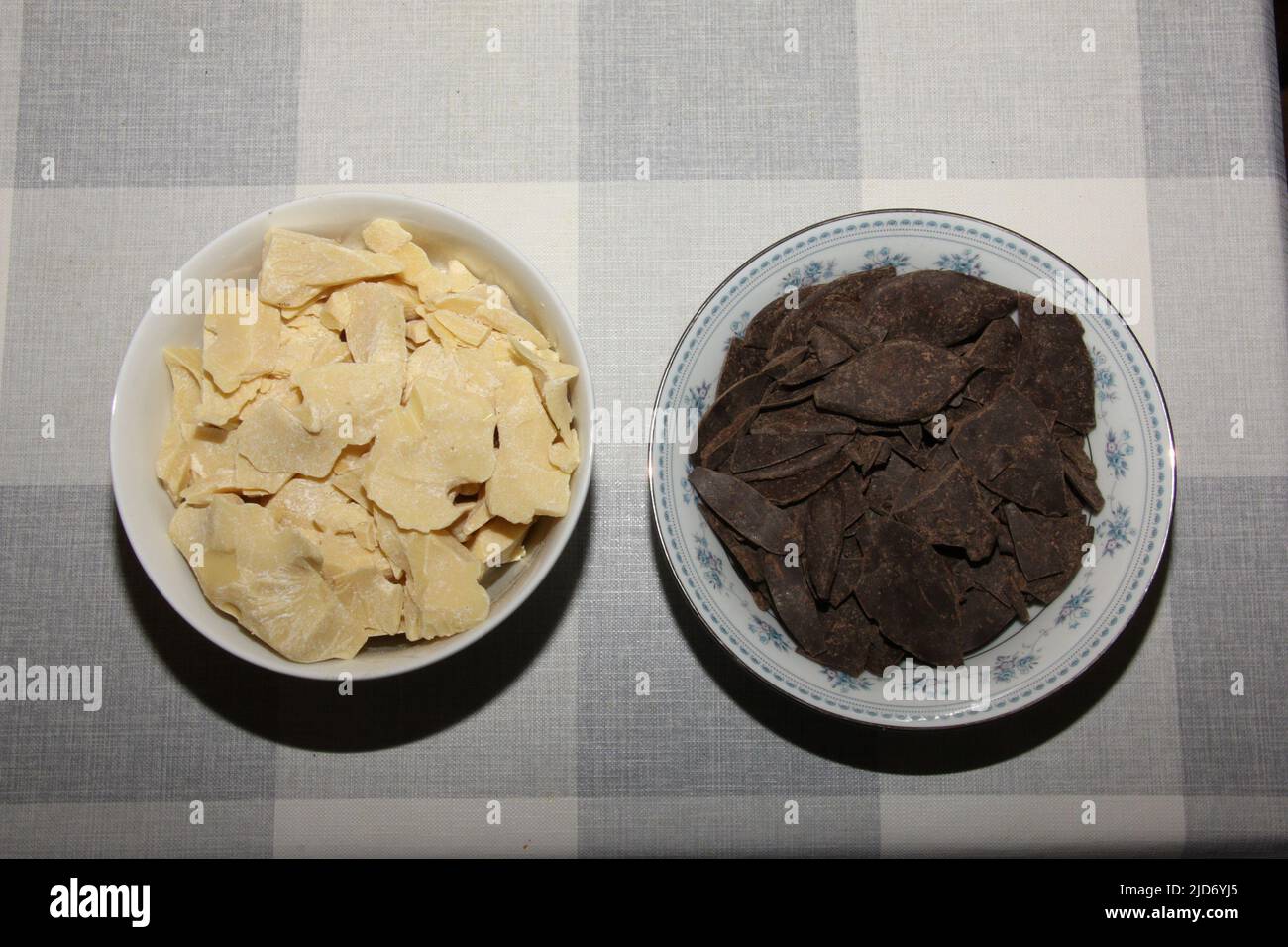 Containers with cocoa butter and grated cocoa, top view, texture. Basic ...