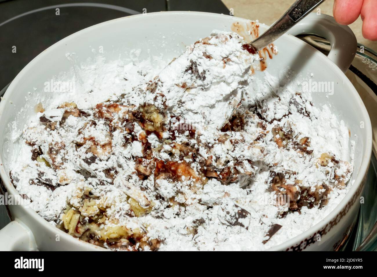 Powdered sugar, cocoa butter and grated cocoa in a container for making ...