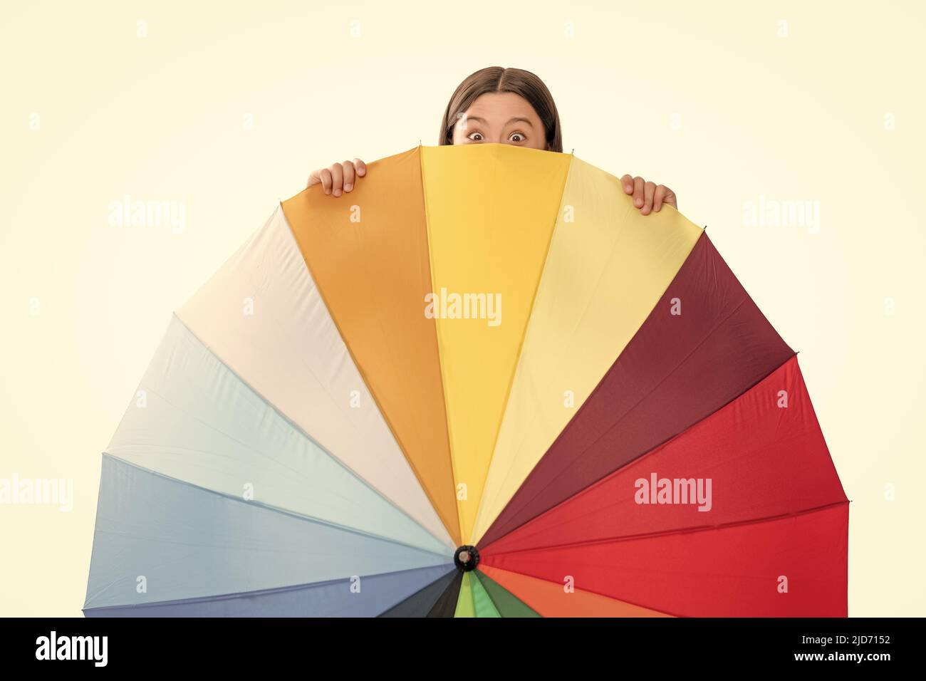 child hiding behind colorful parasol. kid with rainbow umbrella ...