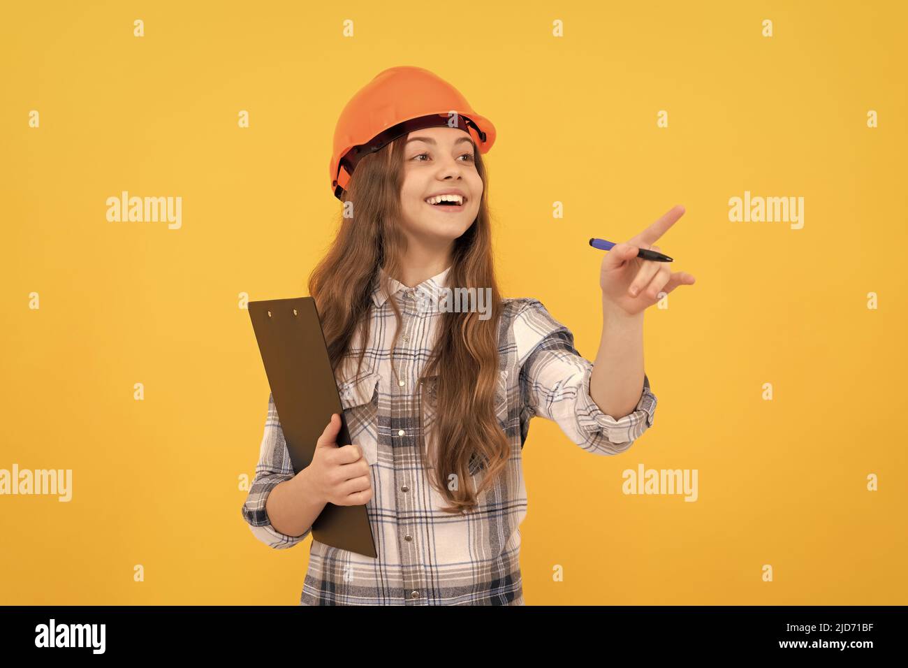 happy labour day. future career. teen girl in helmet making notes ...