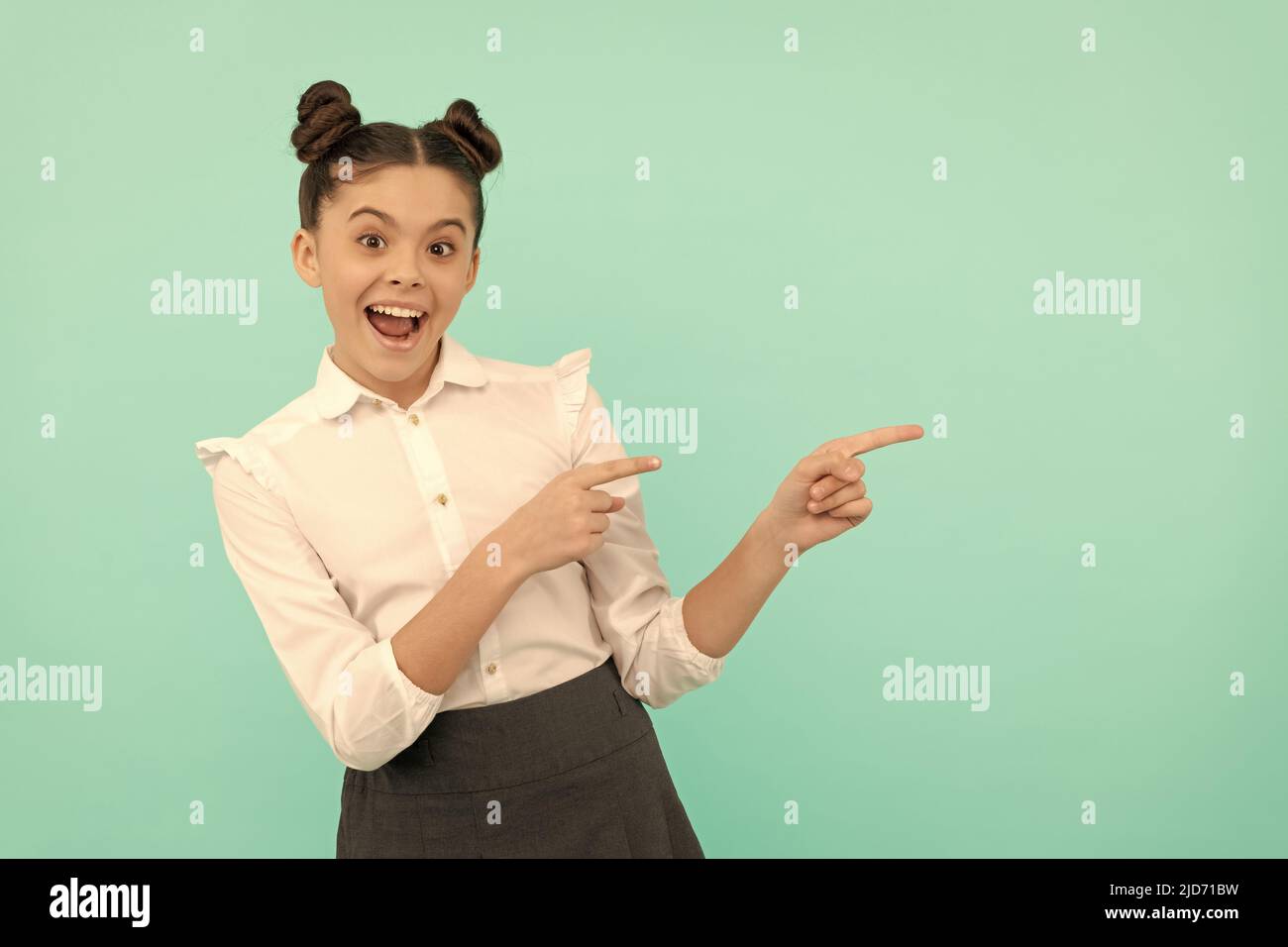 Happy primary school kid point fingers hand gesture for product ...