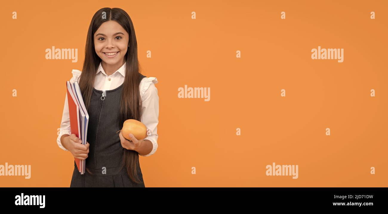 Individual study. Happy schoolgirl hold apple and books. Self study ...