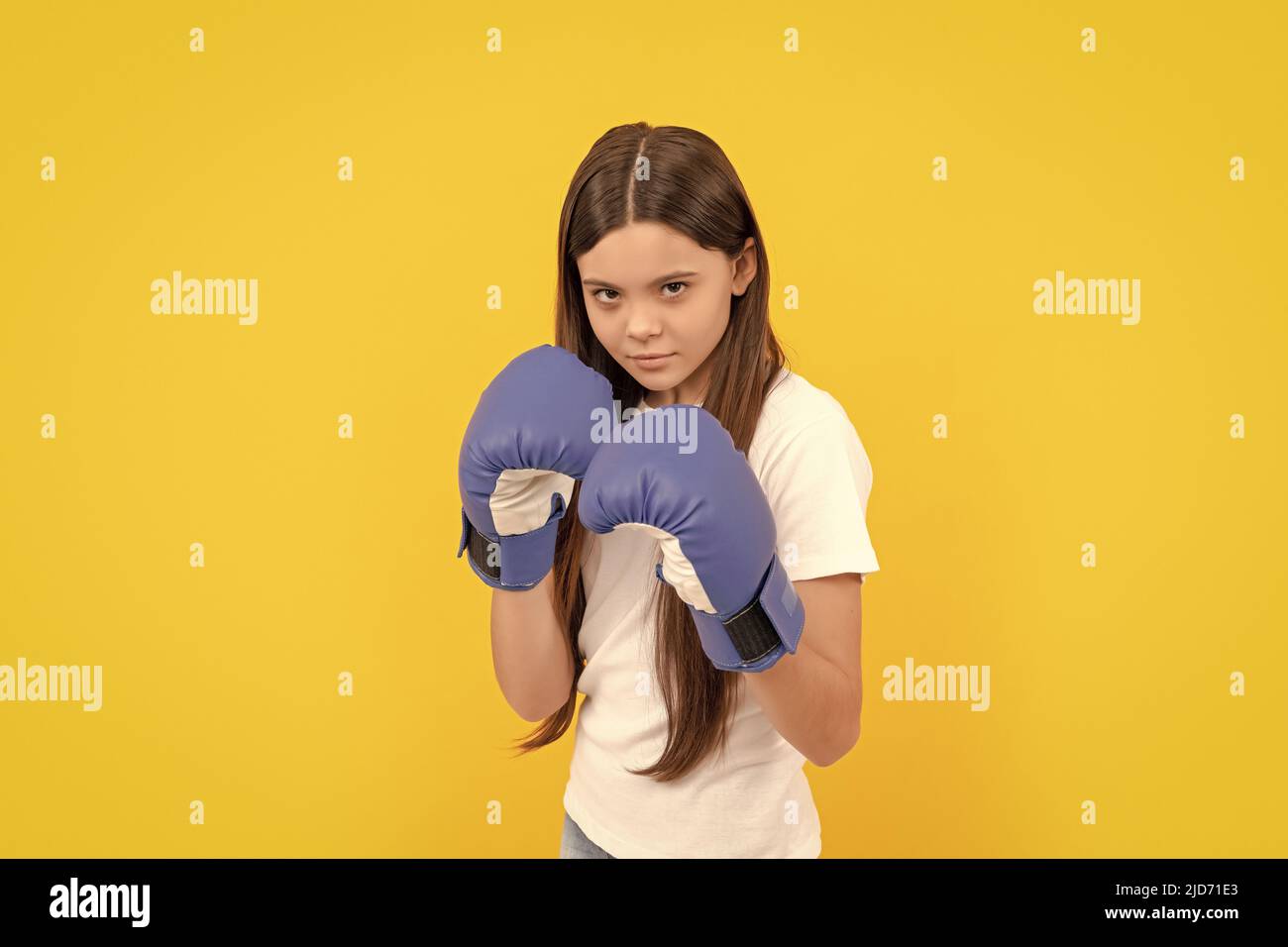 angry child fighting in boxing gloves on yellow background Stock Photo ...
