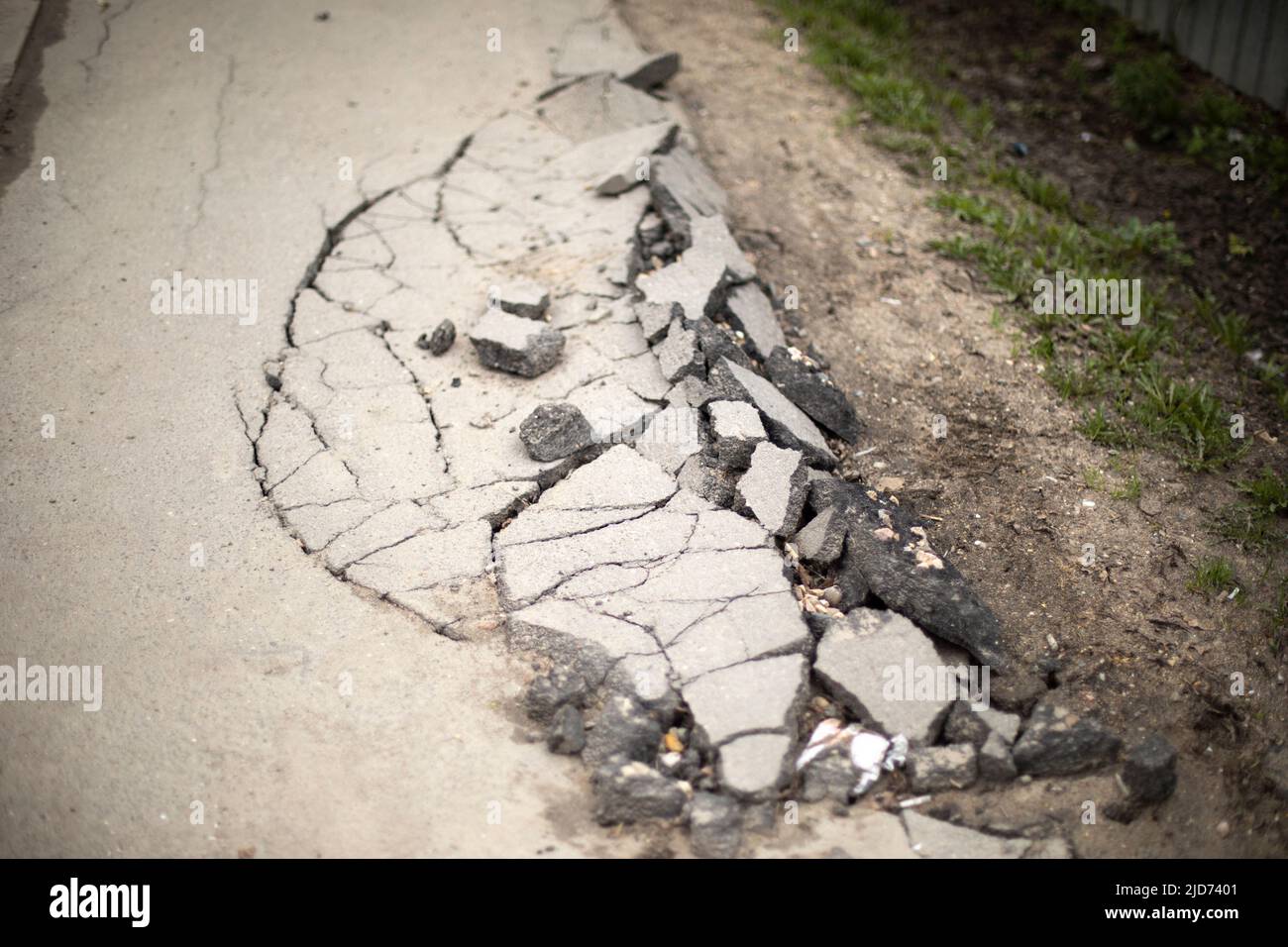 Broken asphalt. Broken road. Destruction of road surface Stock Photo ...