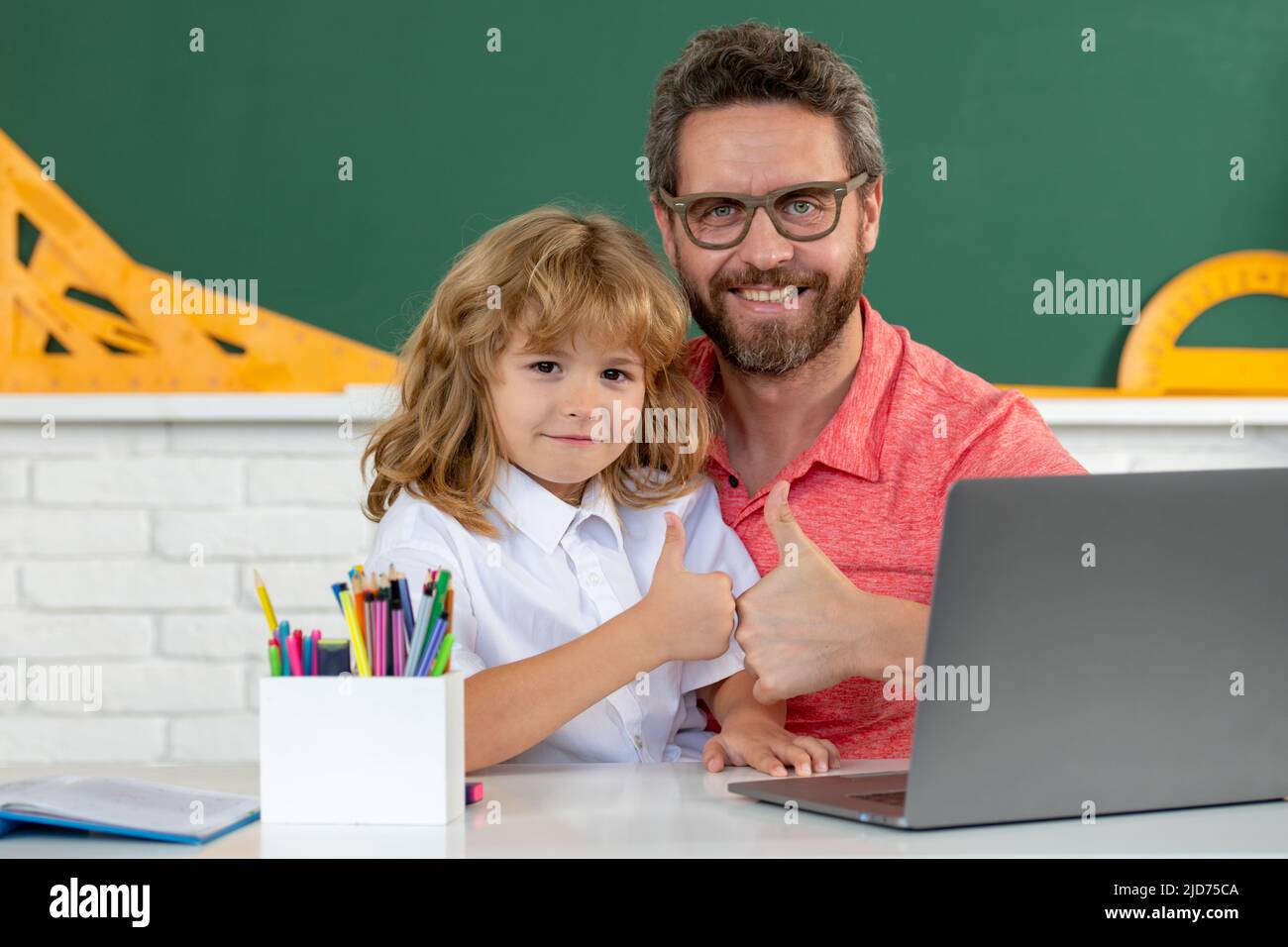 Back to school. Pupil kid student and teacher tutor in classroom at ...