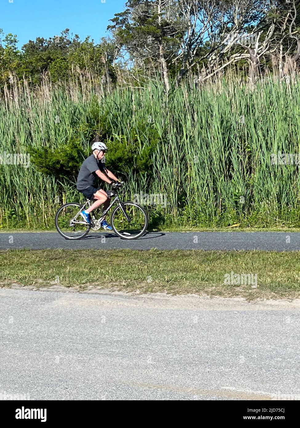 United States President Joe Biden rides his bike as he spends his ...