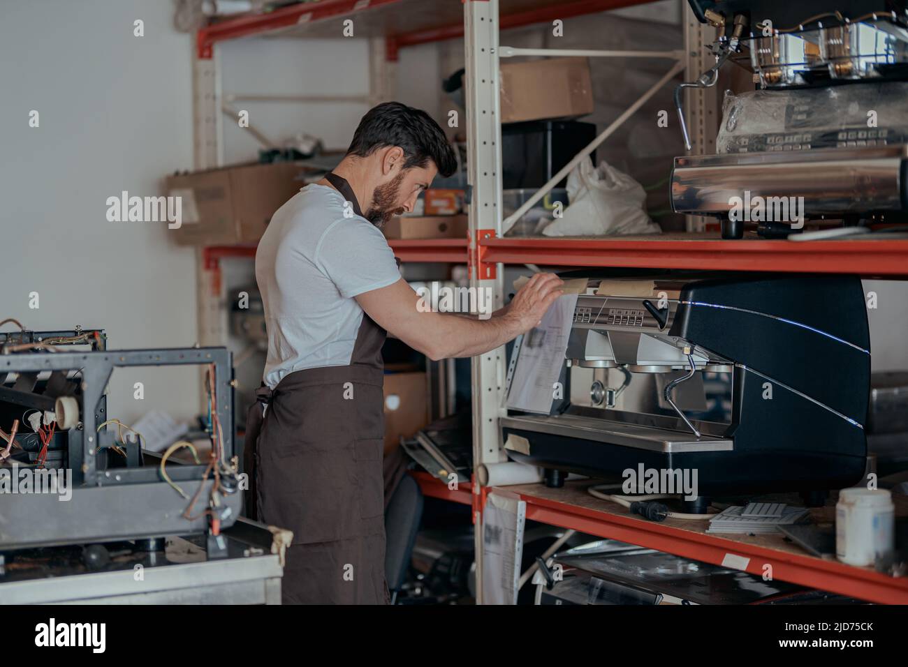 Man fixing coffee machine hi-res stock photography and images - Alamy